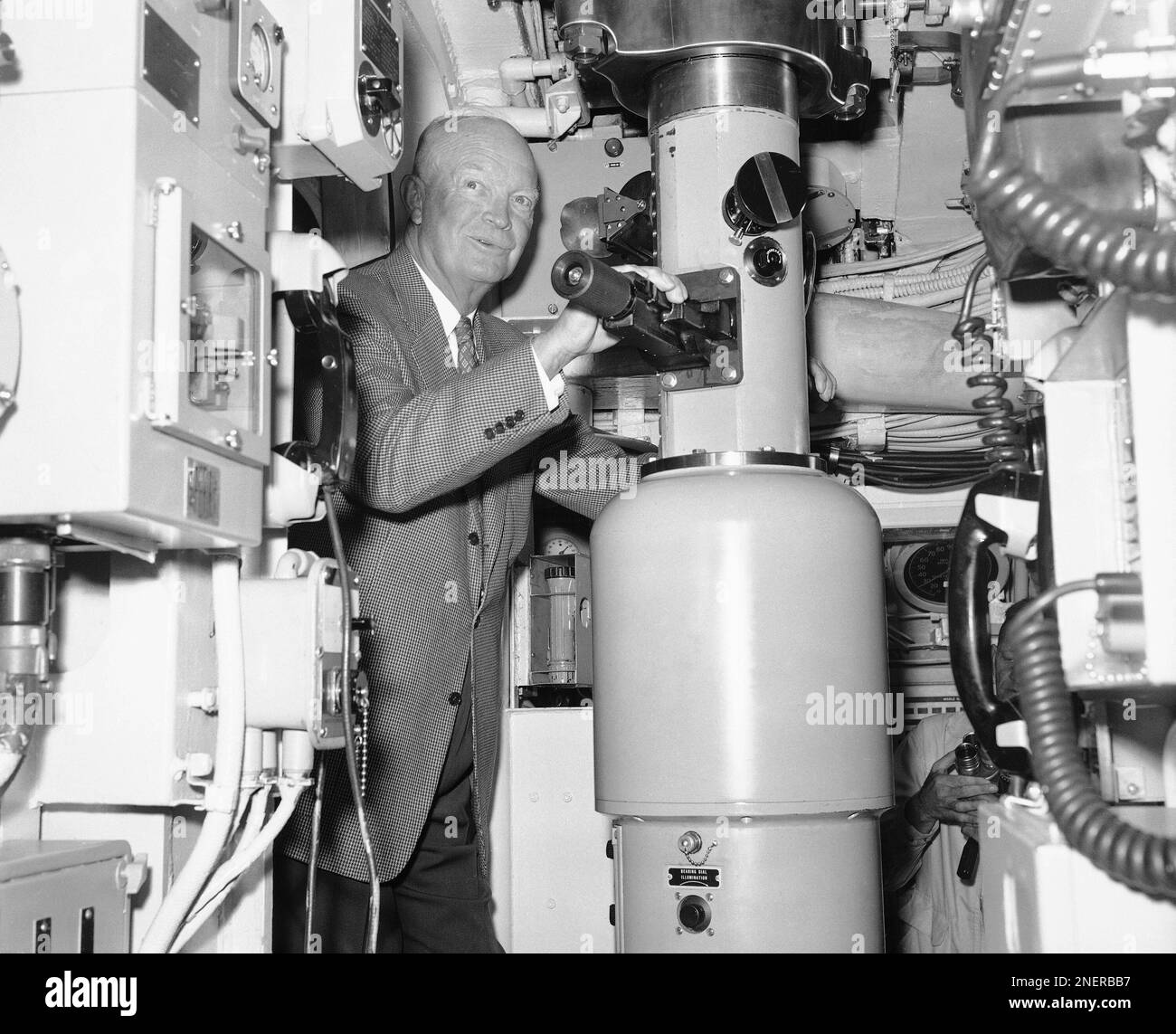 President Dwight Eisenhower takes a look through the periscope of the ...