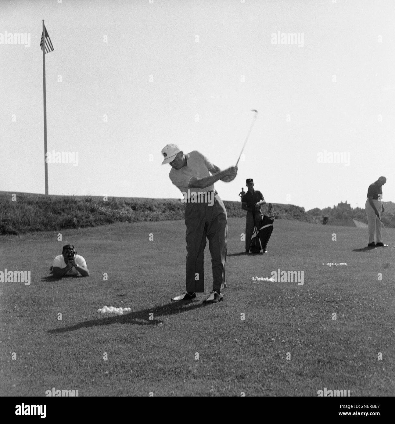 President Dwight Eisenhower practicing shots in front of clubhouse in ...