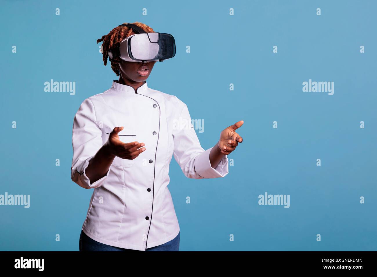 Serious professional chef using VR headset to explore augmented reality ...