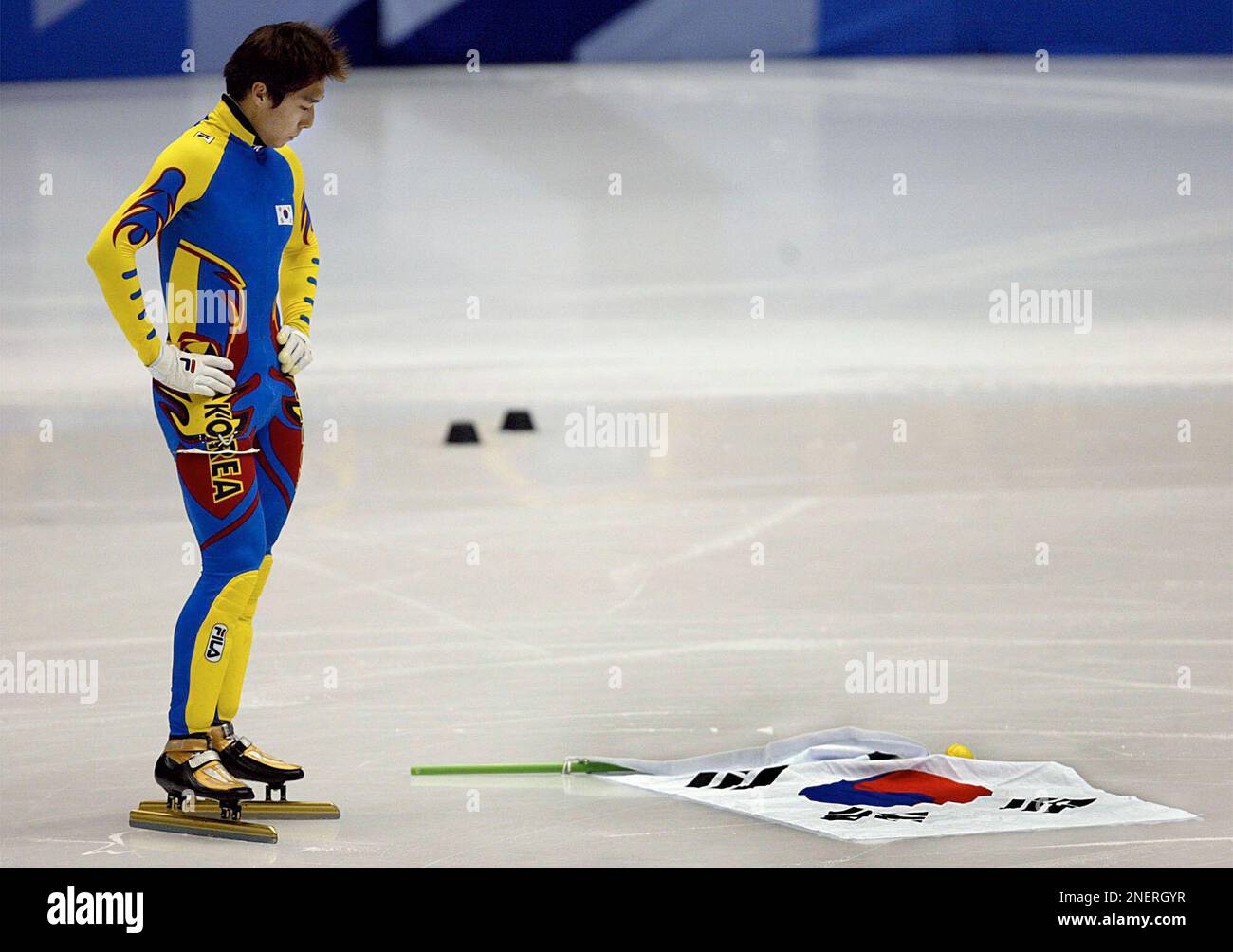 Kim Dong-sung of South Korea looks down at his country's flag after he ...