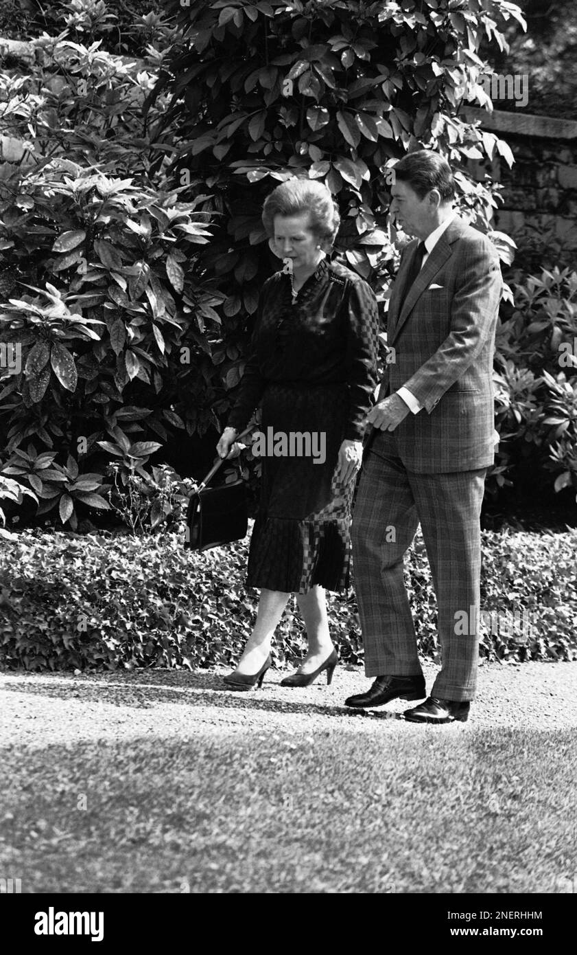 British Prime Minister Margaret Thatcher listens as President Ronald ...