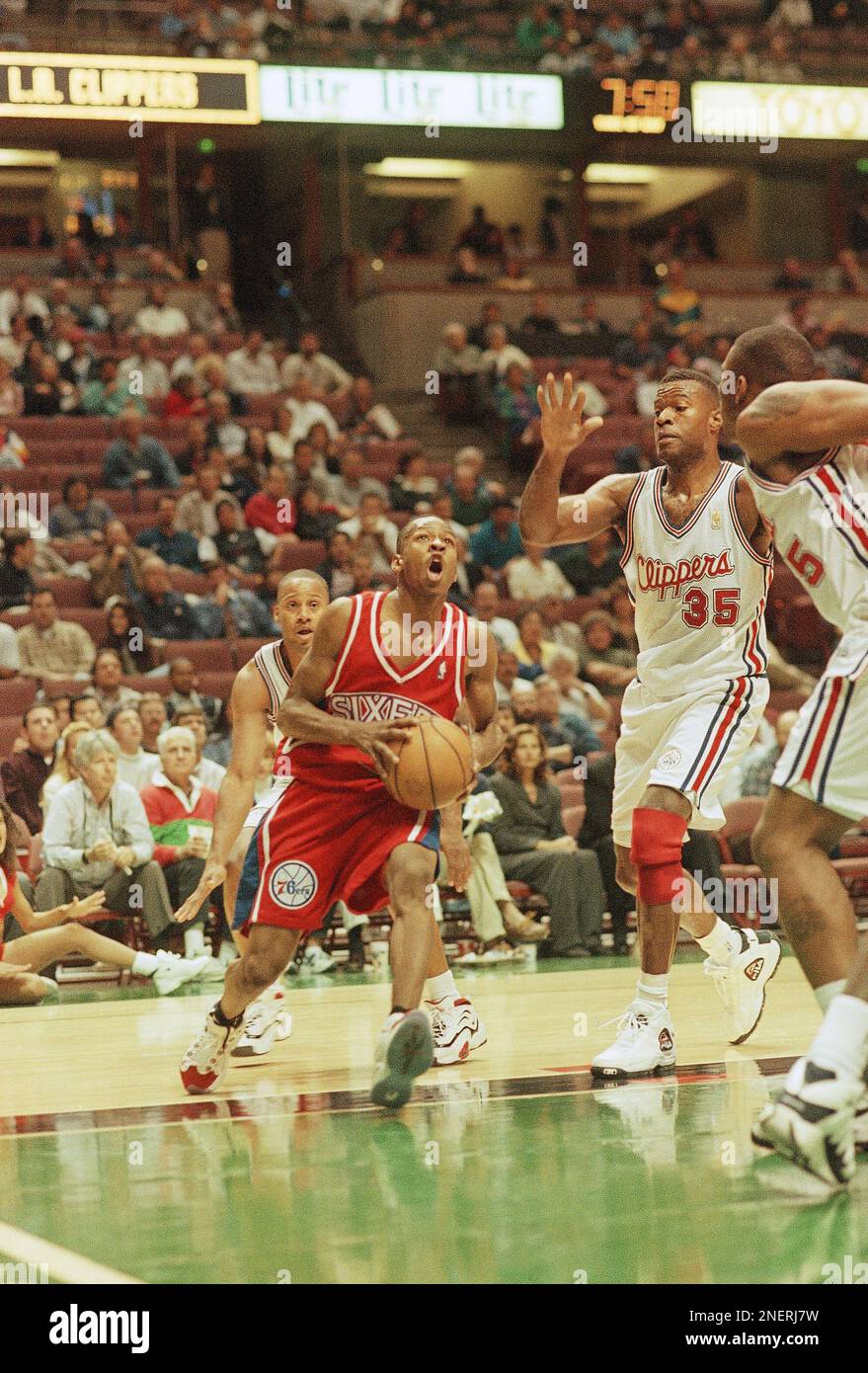 Allen Iverson of the Philadelphia 76ers looks toward the hoop as Pooh ...