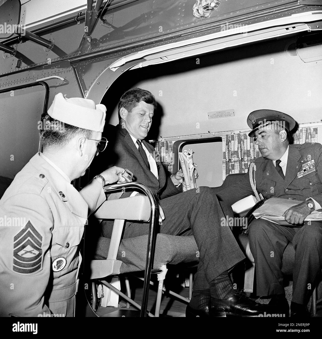 President John F. Kennedy gets an assist from Air Force Colonel Godfrey ...