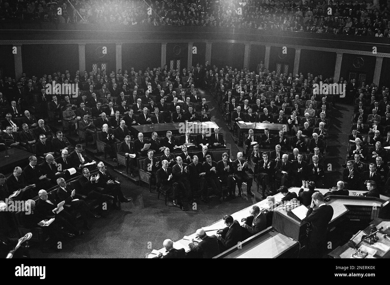 Members of the cabinet, seated in the front row, applaud President ...