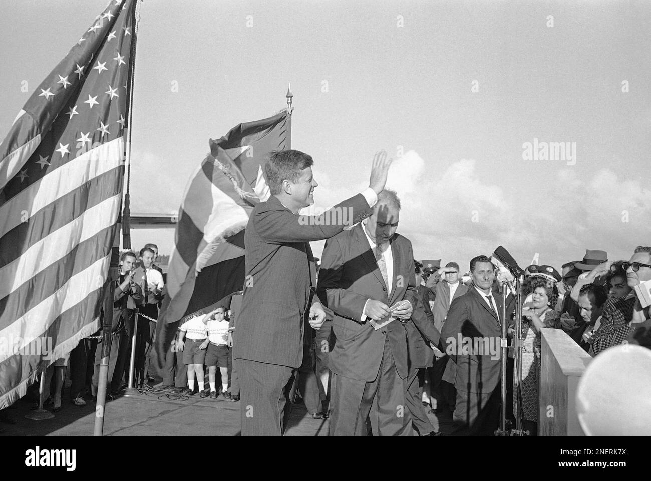President John F. Kennedy waves to a cheering crowd at San Juan airport ...