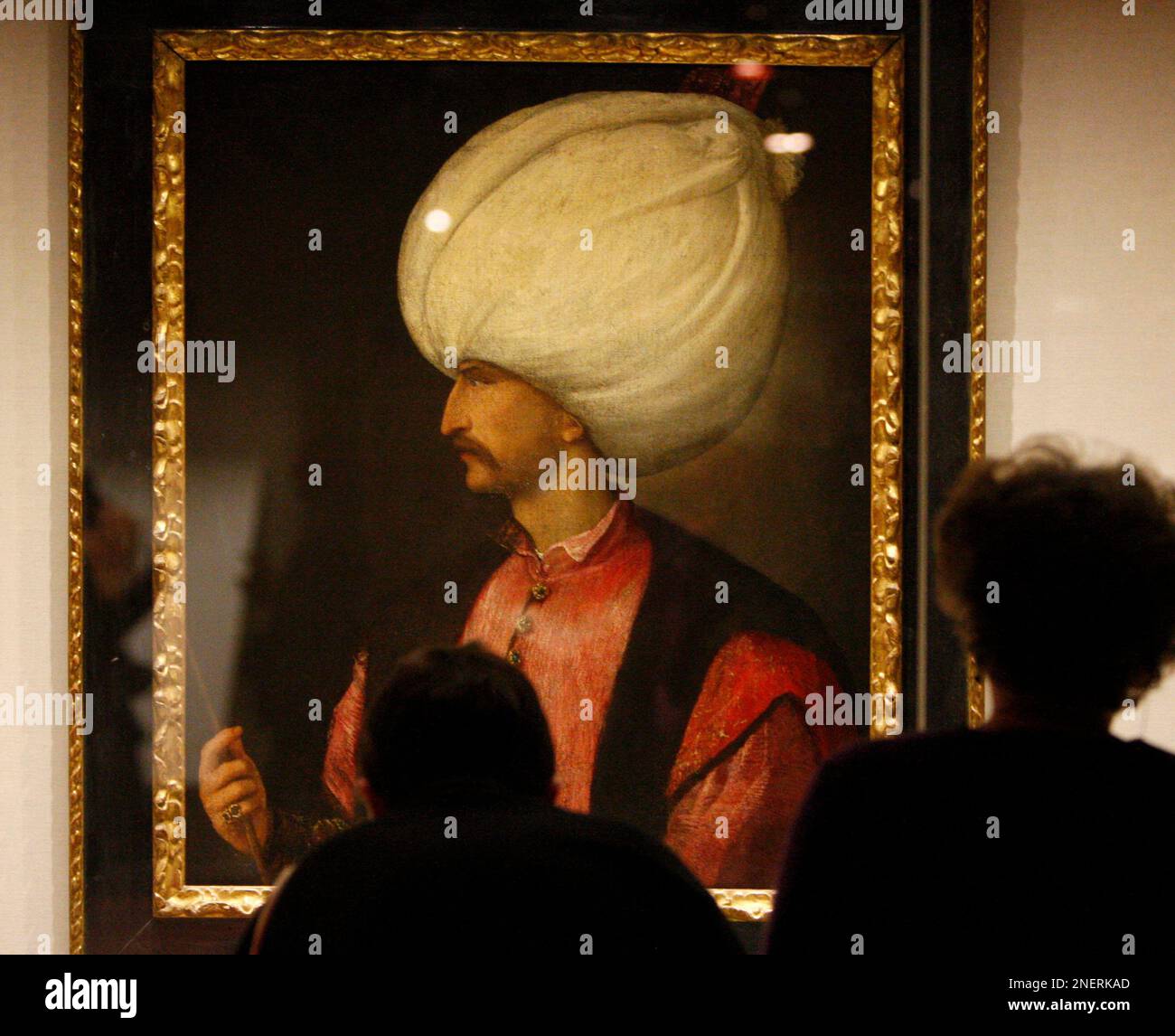 Visitors look at a painting of Sultan Suleiman I the Magnificent ...