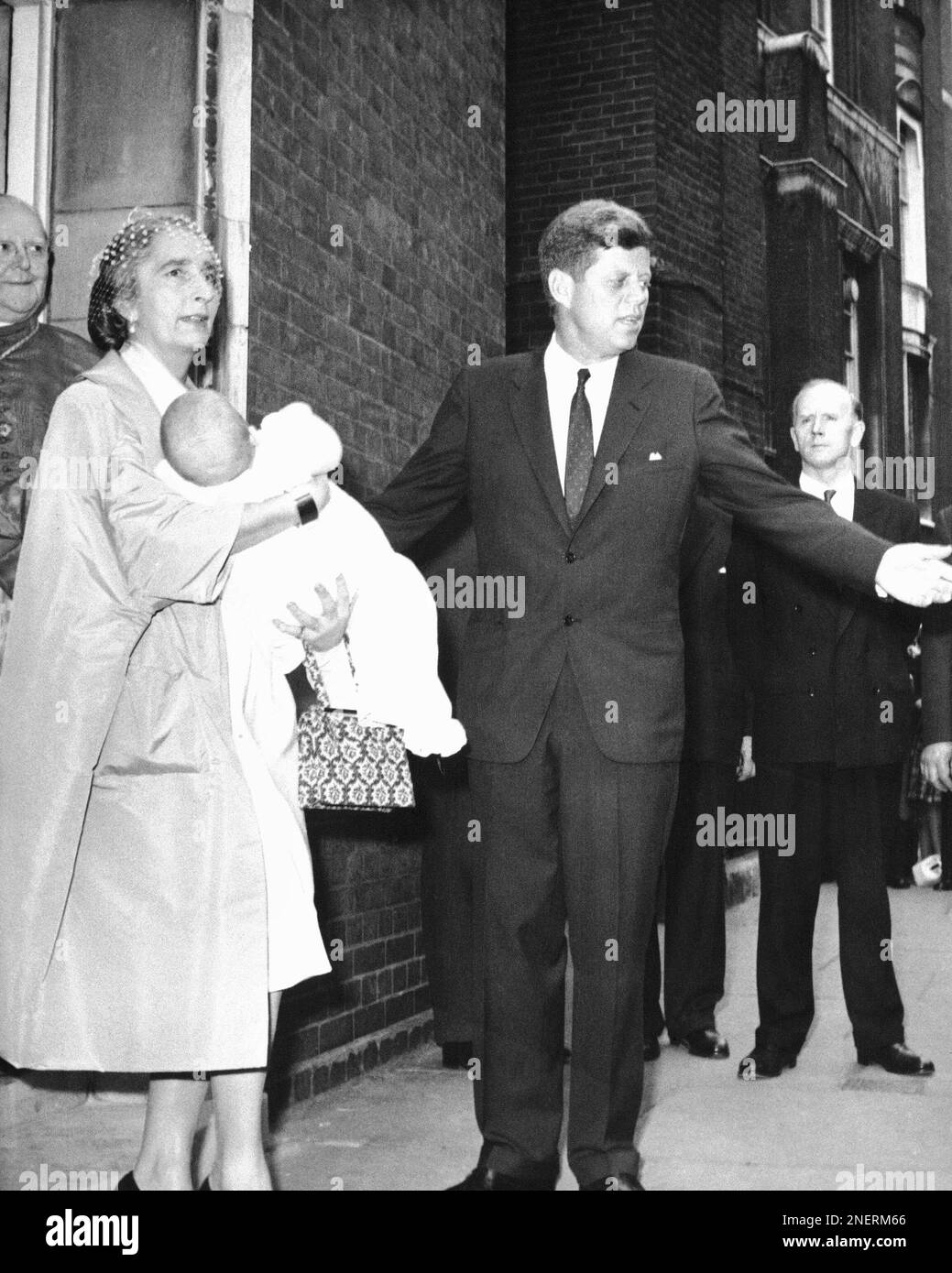 President John Kennedy waves an arm to clear the way for newly ...