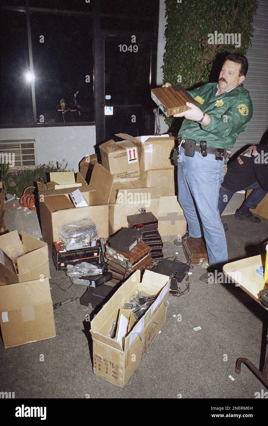 Los Angeles County Sheriff Deputy Frank Konrad checks the number on one ...