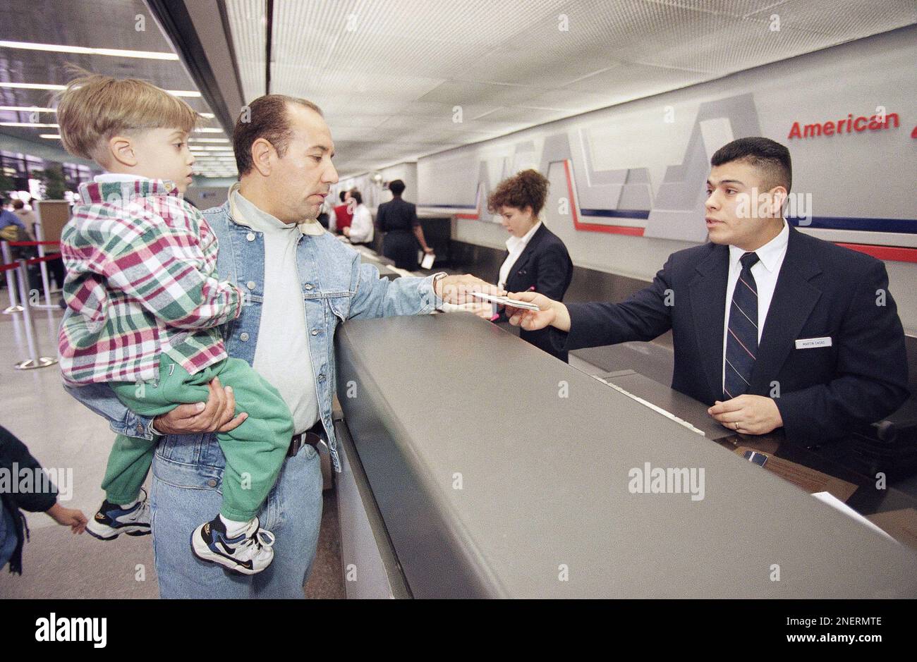 Carmelo Ierna of Australia holds his son Dominic, left, as he receives ...