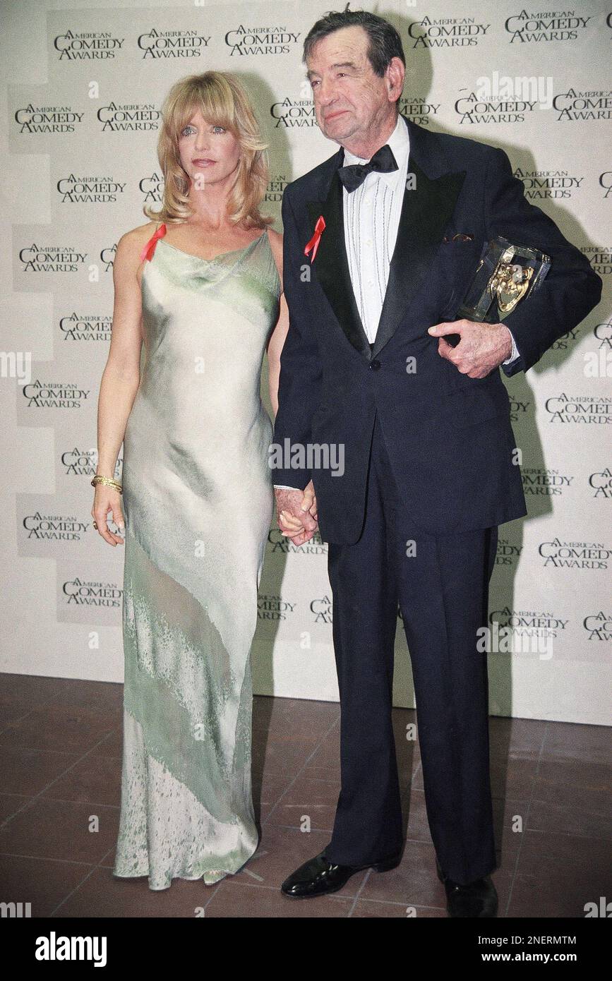 Actress Goldie Hawn poses with actor Walter Matthau as he holds a ...