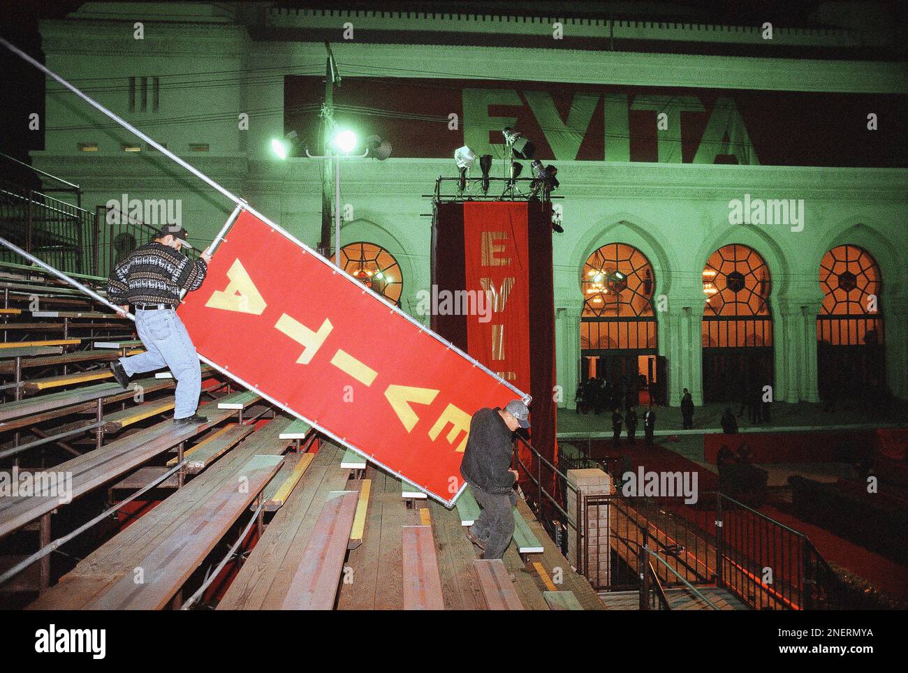 Laborers Eni Ortiz, left, and Mark Tapie take down ?Evita? signs at the ...
