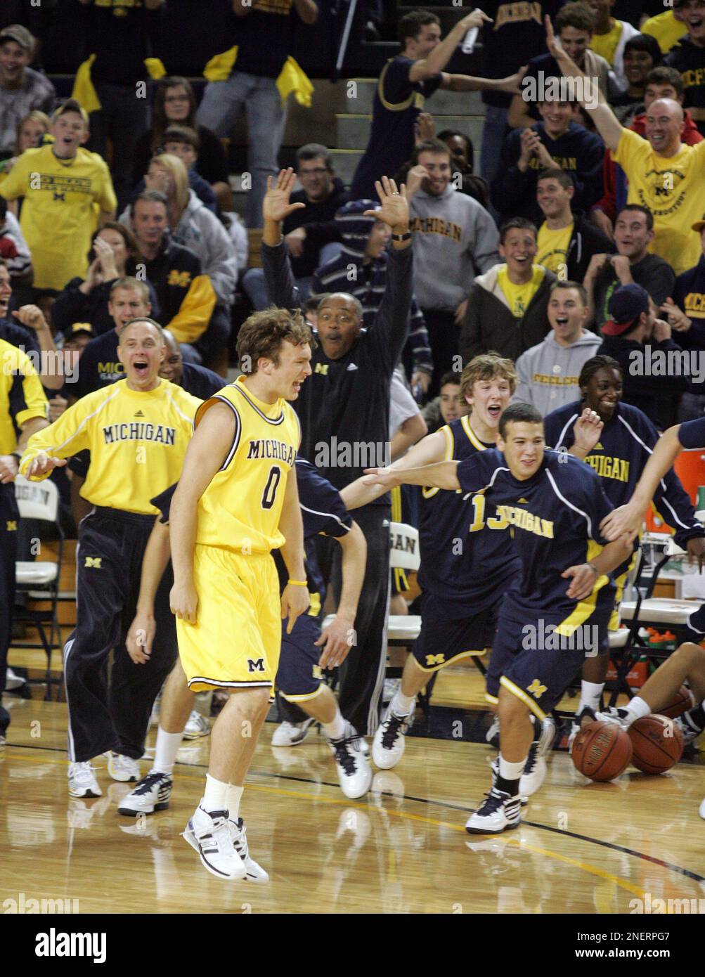 Michigan guard Zack Novak (0) reacts with teammates and fans after ...