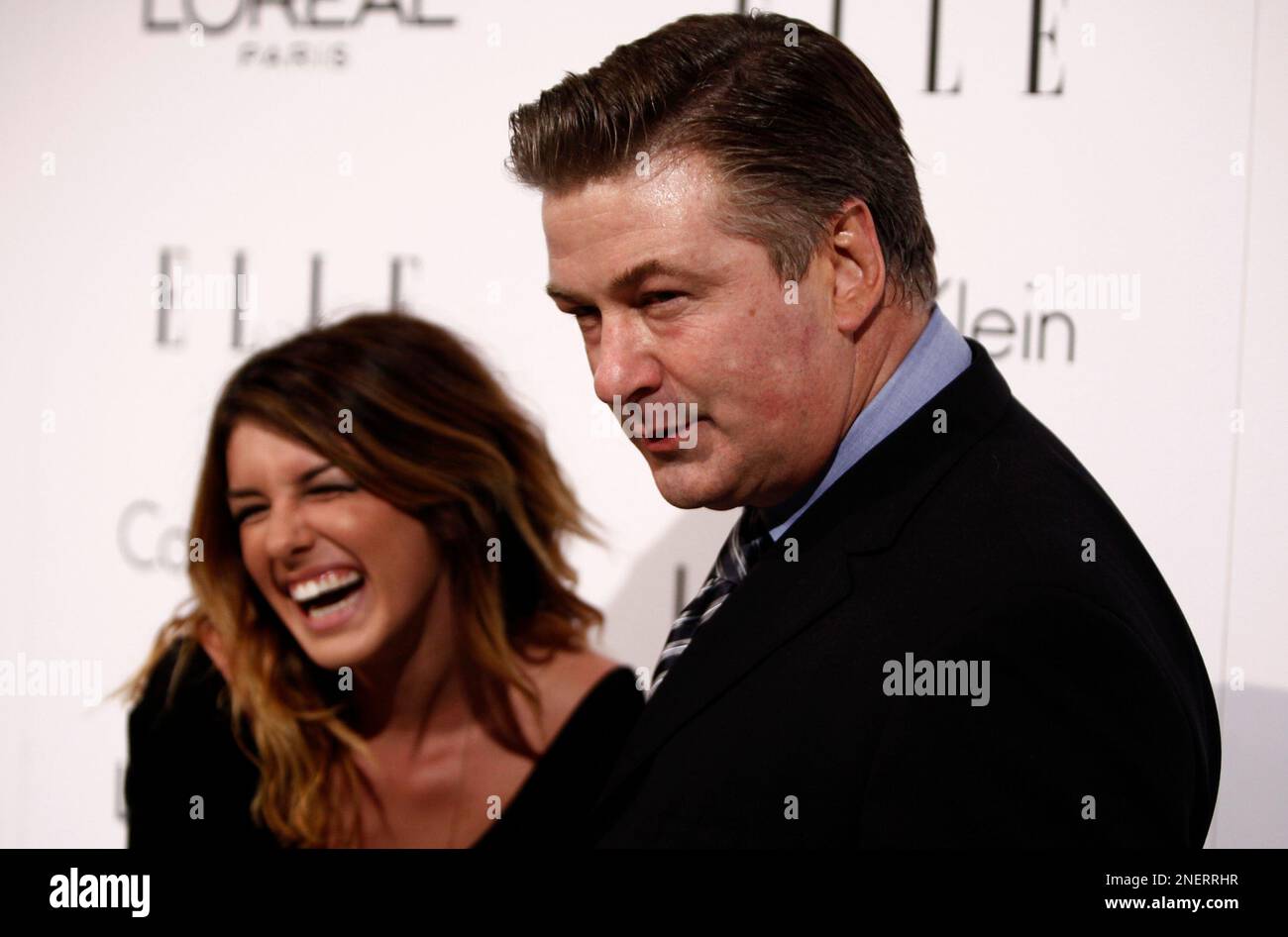 Actress Shenae Grimes, left, laughs as actor Alec Baldwin arrives for ...