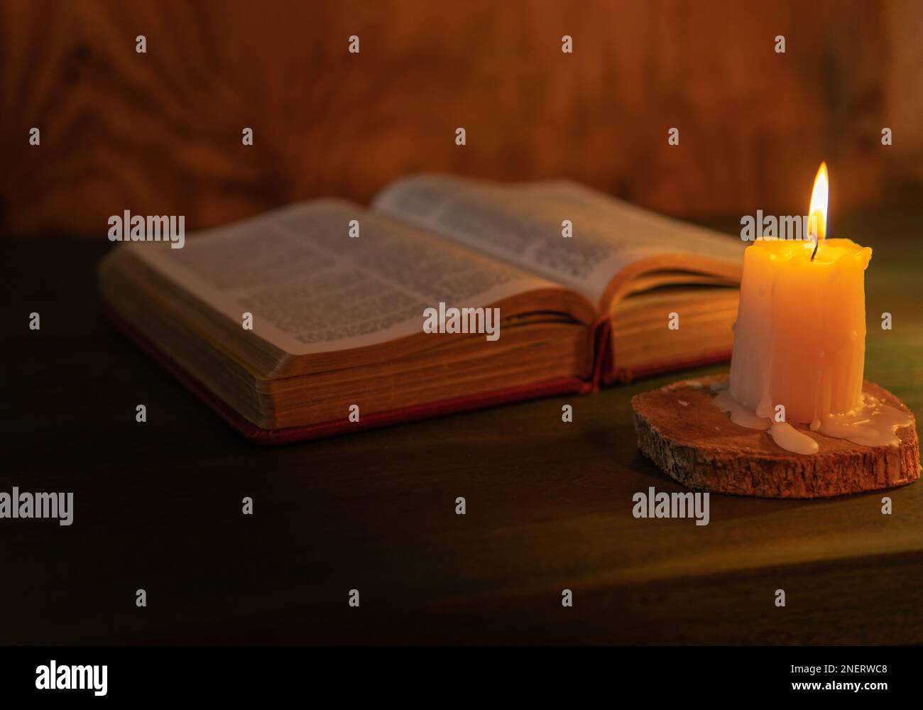 Selective focus of a candle lighting up on a bible. Religious message ...