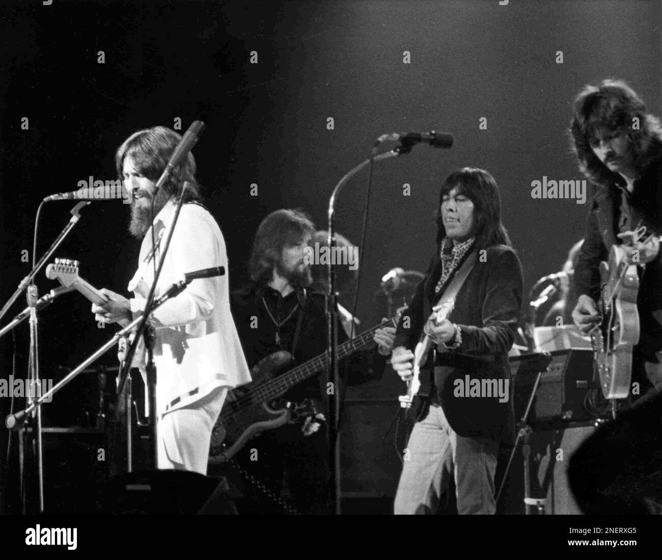 Former Beatle George Harrison, left, performs at a benefit concert for ...
