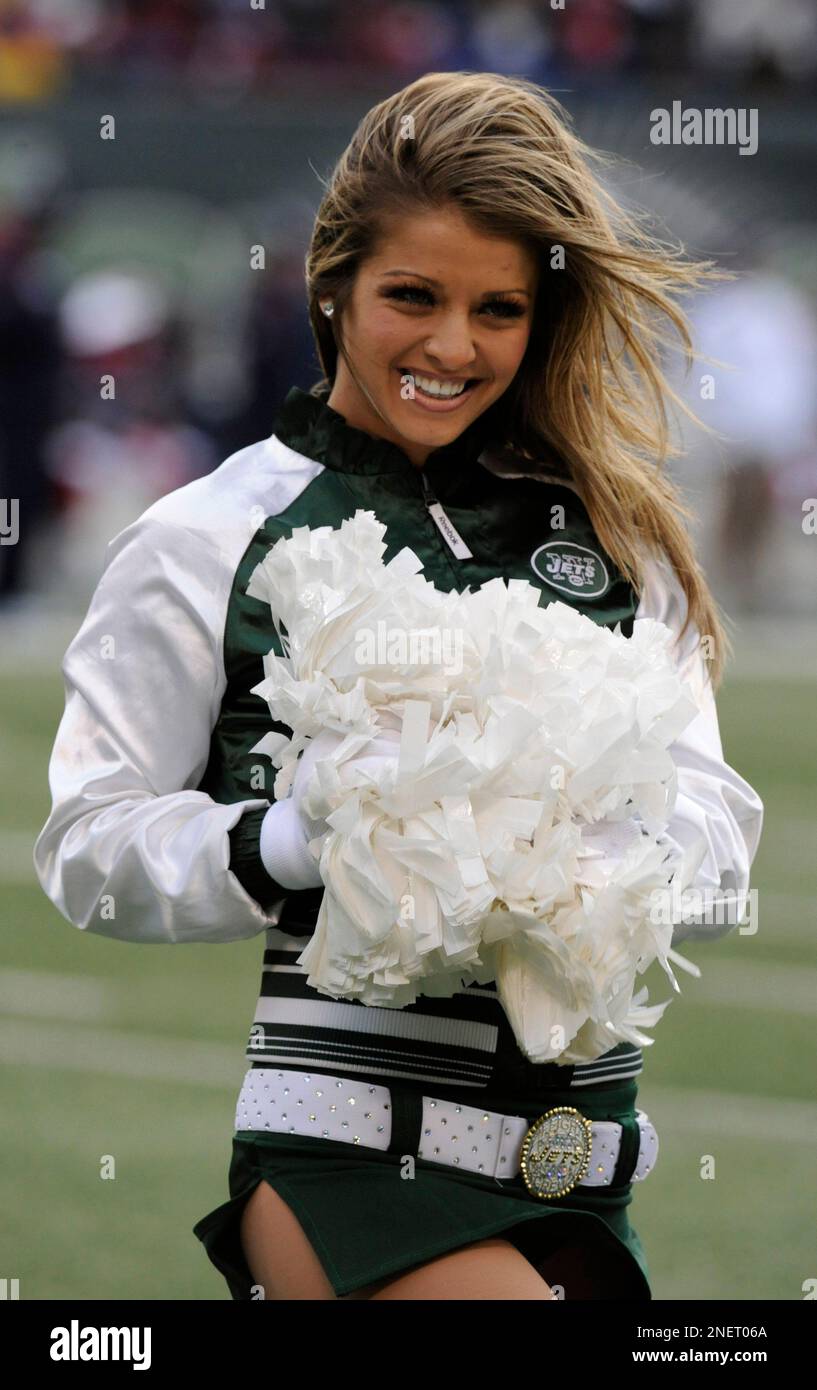 A New York Jets cheerleader looks on during the first quarter of an NFL ...