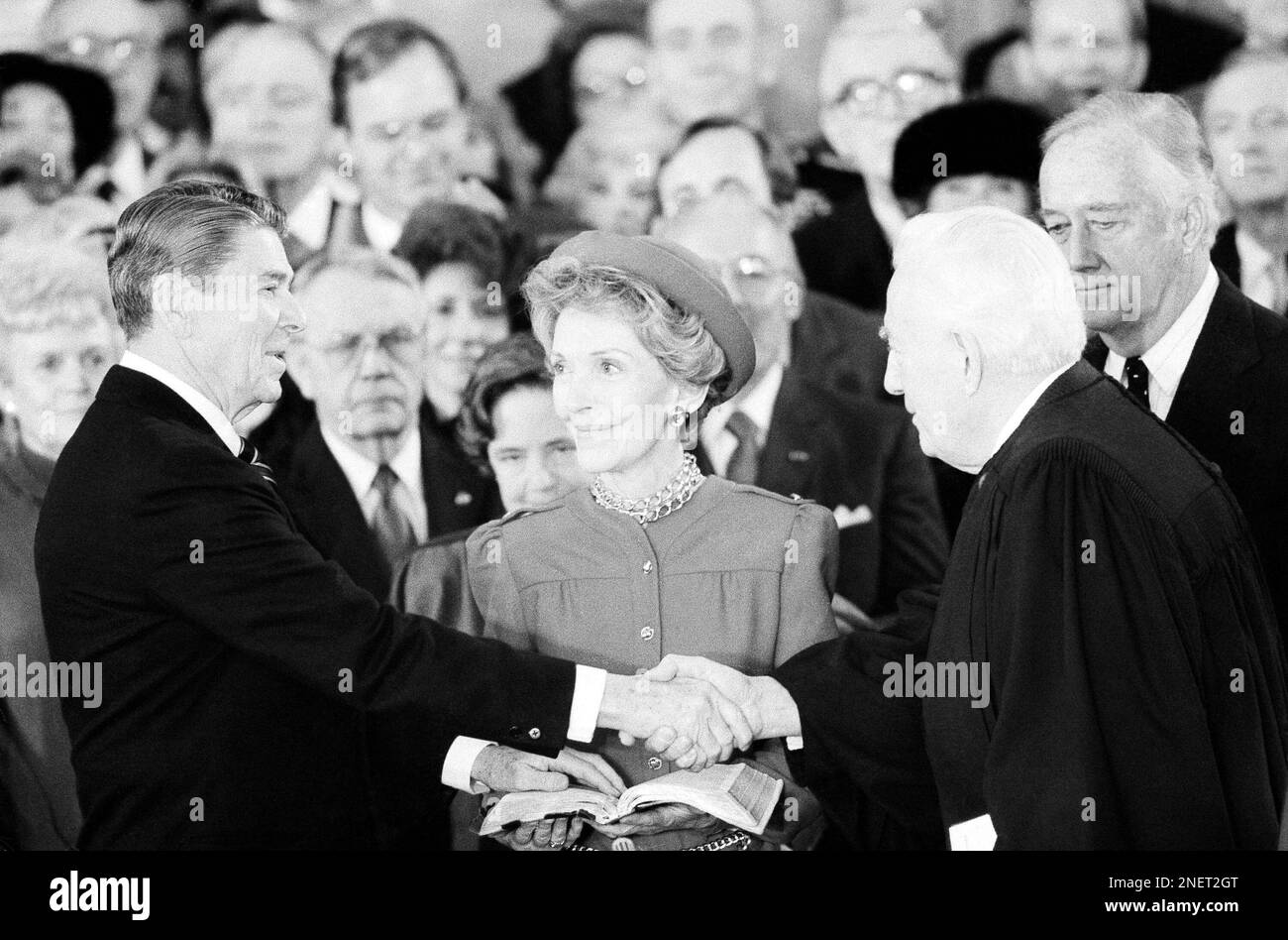 Standing holding shaking hands smiling looking authority book hi-res ...