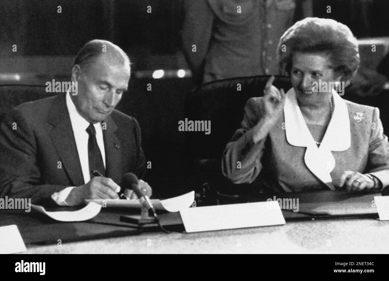 Great Britain?s Prime Minister Margaret Thatcher glimpses over the ...