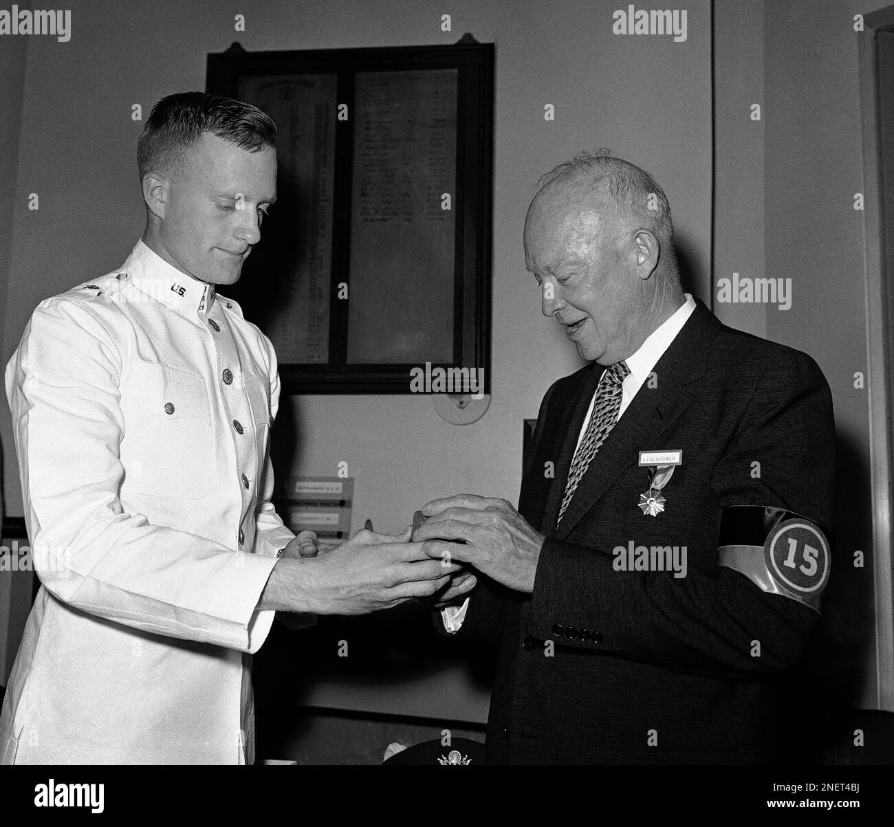 President Eisenhower tries on a 1960 class ring for size after it was ...
