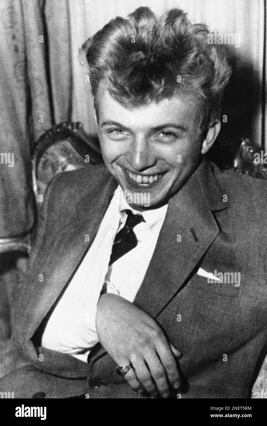 British rock and roll singer Tommy Steele, his right arm in a sling ...