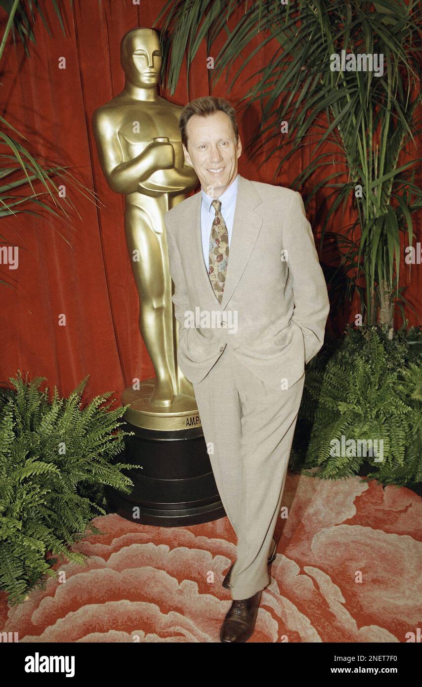 Actor James Woods poses near an Oscar statue as he arrives on Tuesday ...
