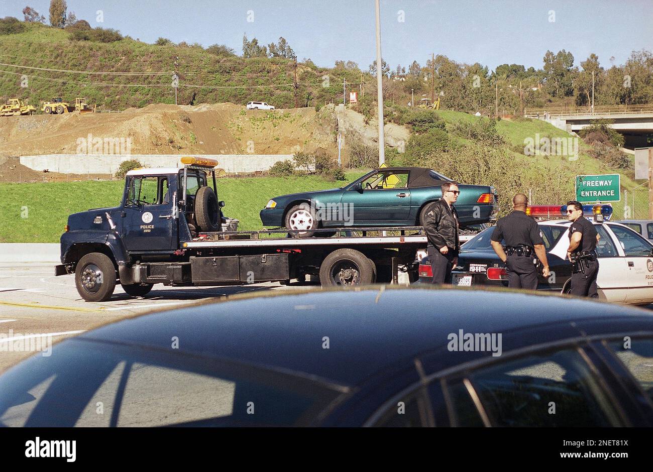 Los Angeles Police Officers stand by the scene where the body of Ennis ...