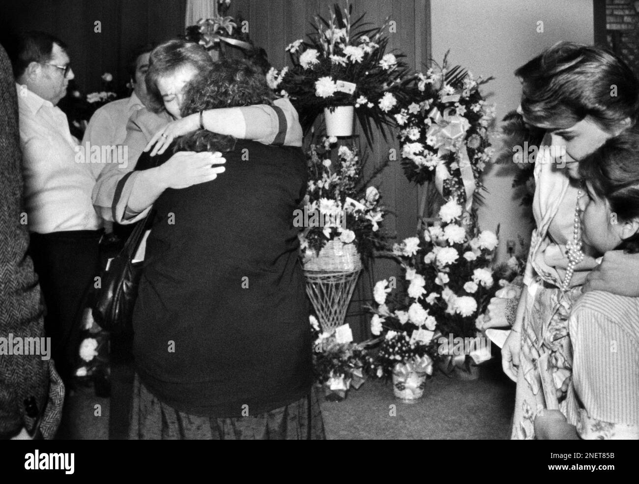 Karen Moritz, mother of shooting victim Glenda Moritz, hugs a friend as ...