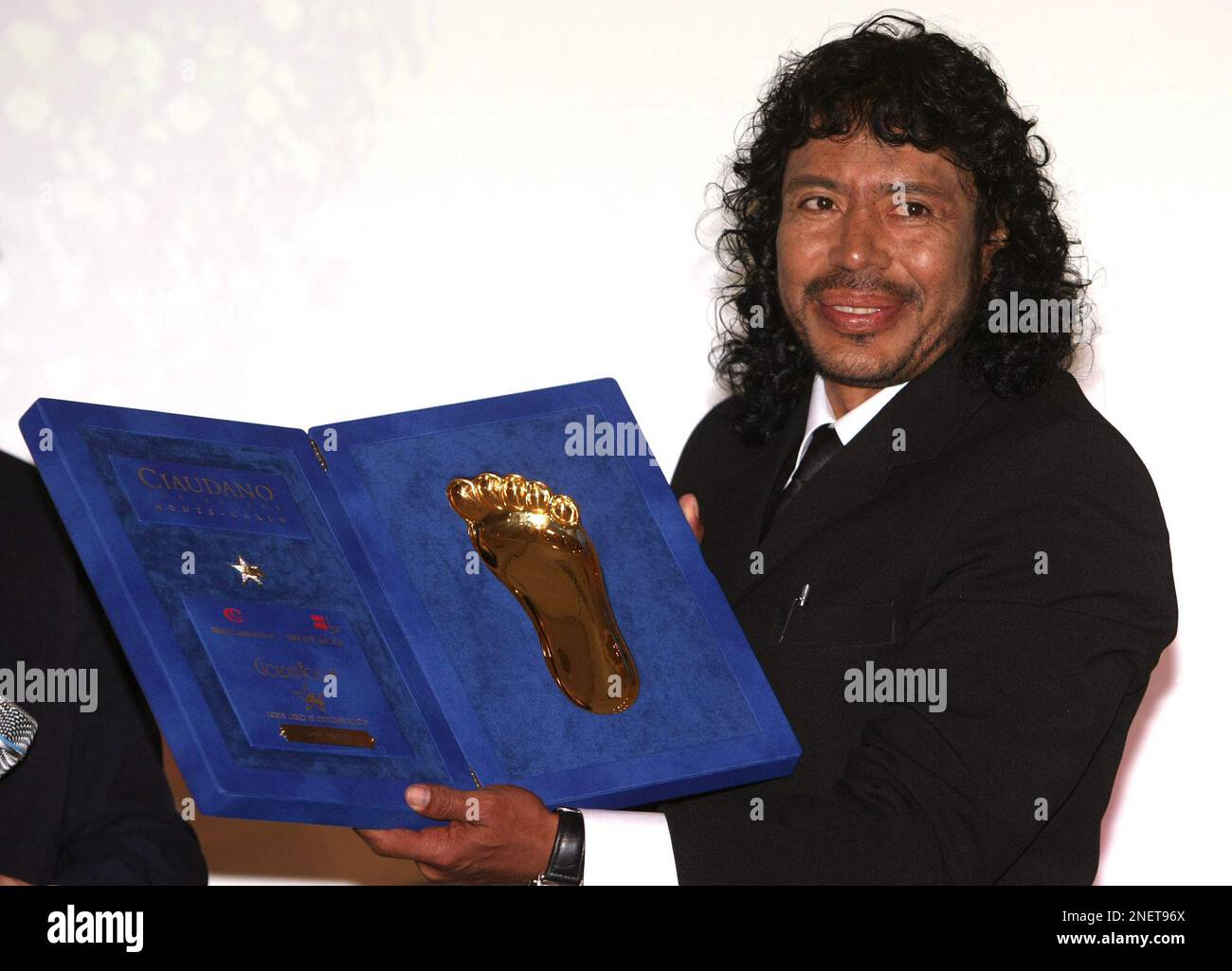 Former Colombian goalkeeper Rene Higuita poses with his "Golden Foot ...