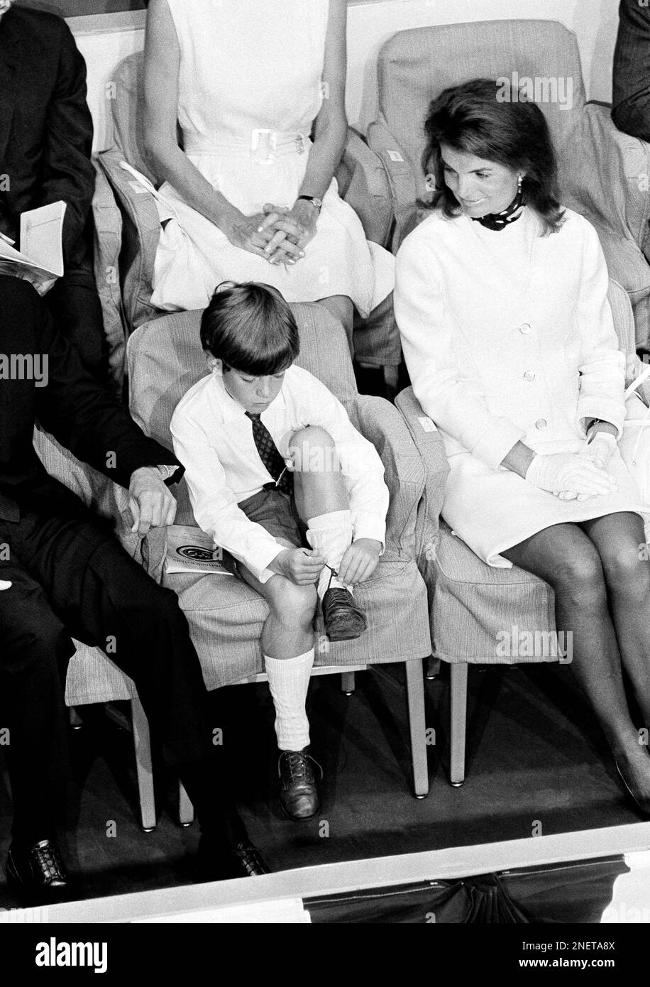 John F. Kennedy Jr. does a bit of shoe tying during commissioning ...