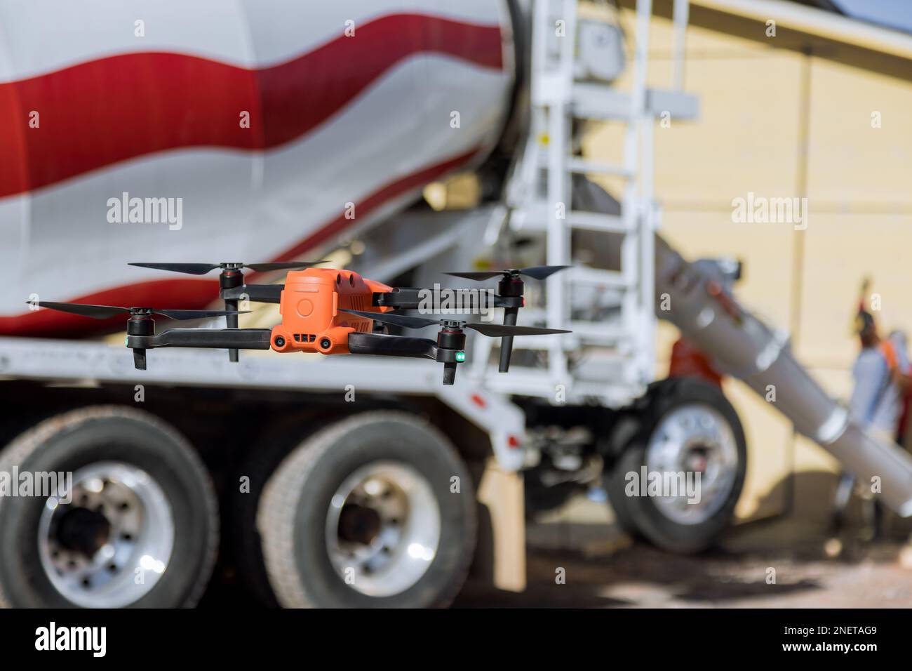 Using drone inspector controls pouring of concrete by employees near ...