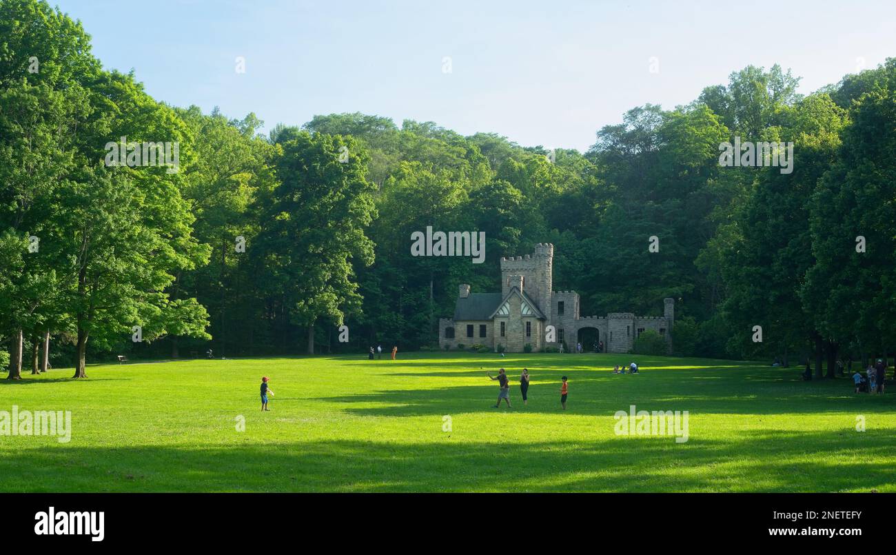 Visitors play and relax on the great lawn before Squires Castle, a ...