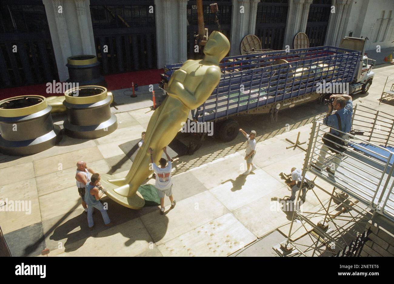 A giant 24-foot Oscar prop statue is laid down in front of the Shrine ...