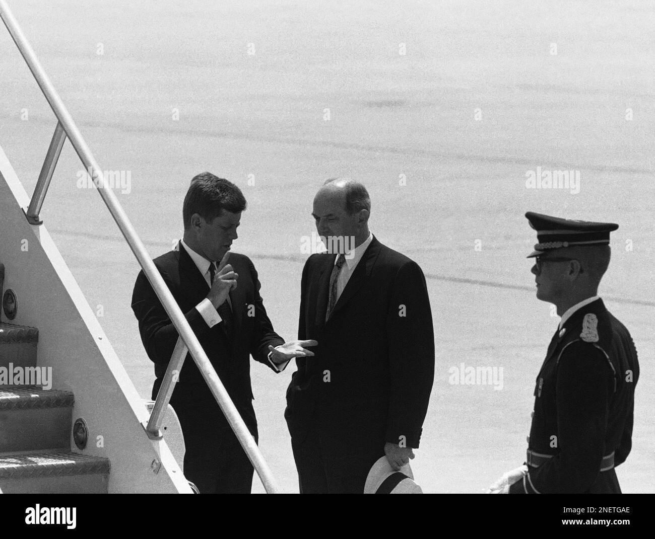 President John Kennedy emphasizes his words with a two-handed gesture ...
