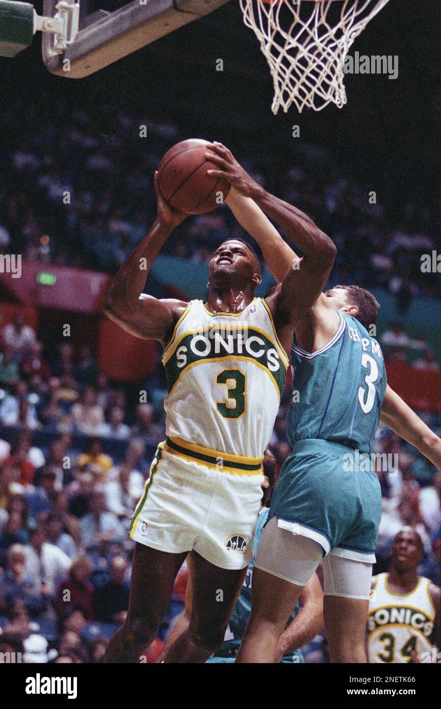 Dale Ellis (3) of the Seattle SuperSonics is fouled on a drive to the basket by Rex Chapman (3 ...