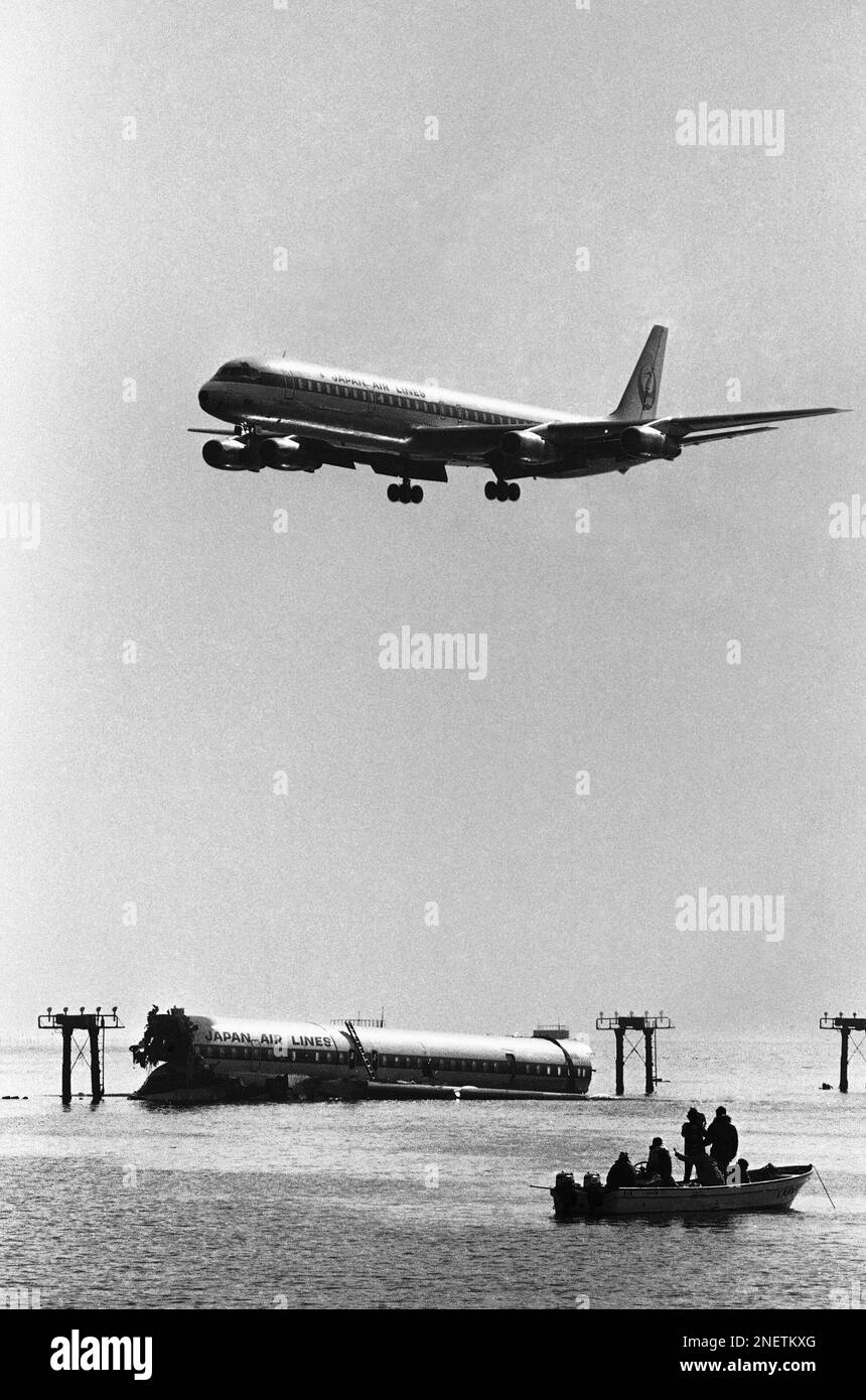Japan Airline’s DC-8 flies over the wreckage of JAL’s DC-8, which ...