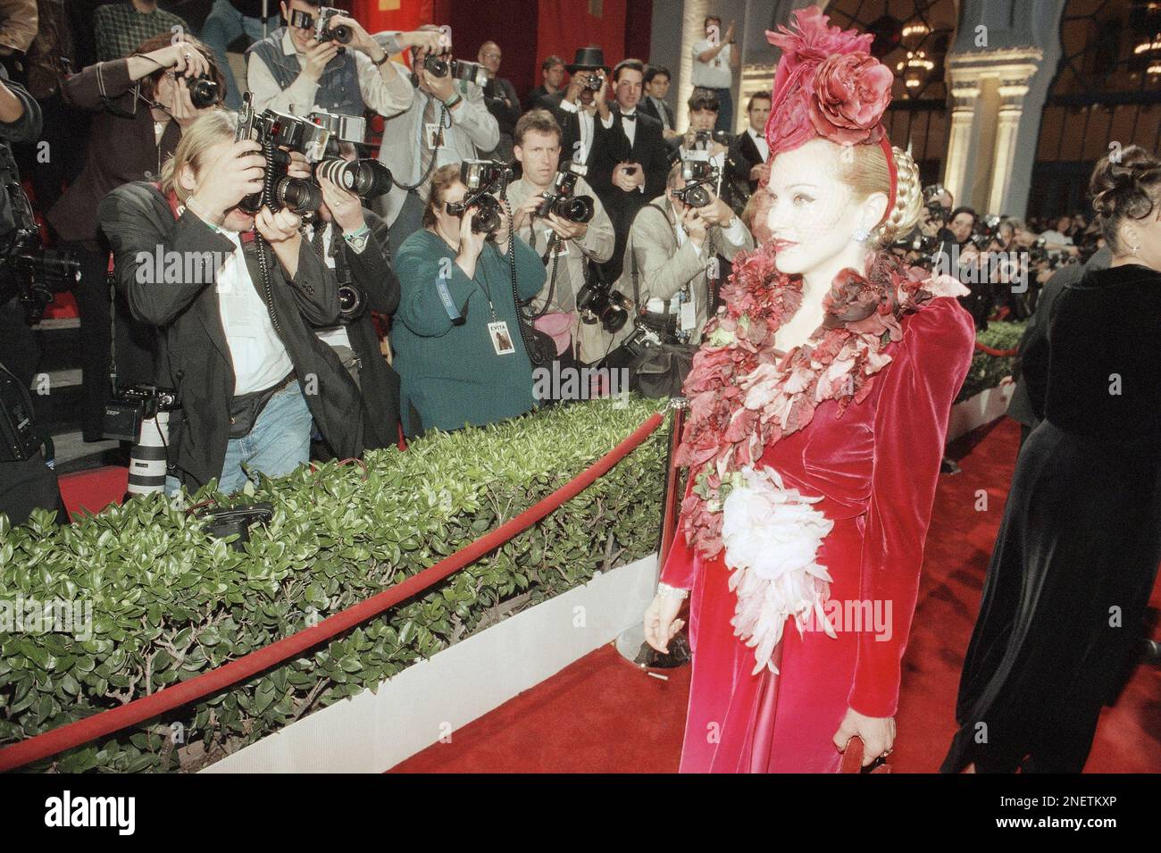 “Evita” star Madonna poses for dozens of photographers as she arrives ...