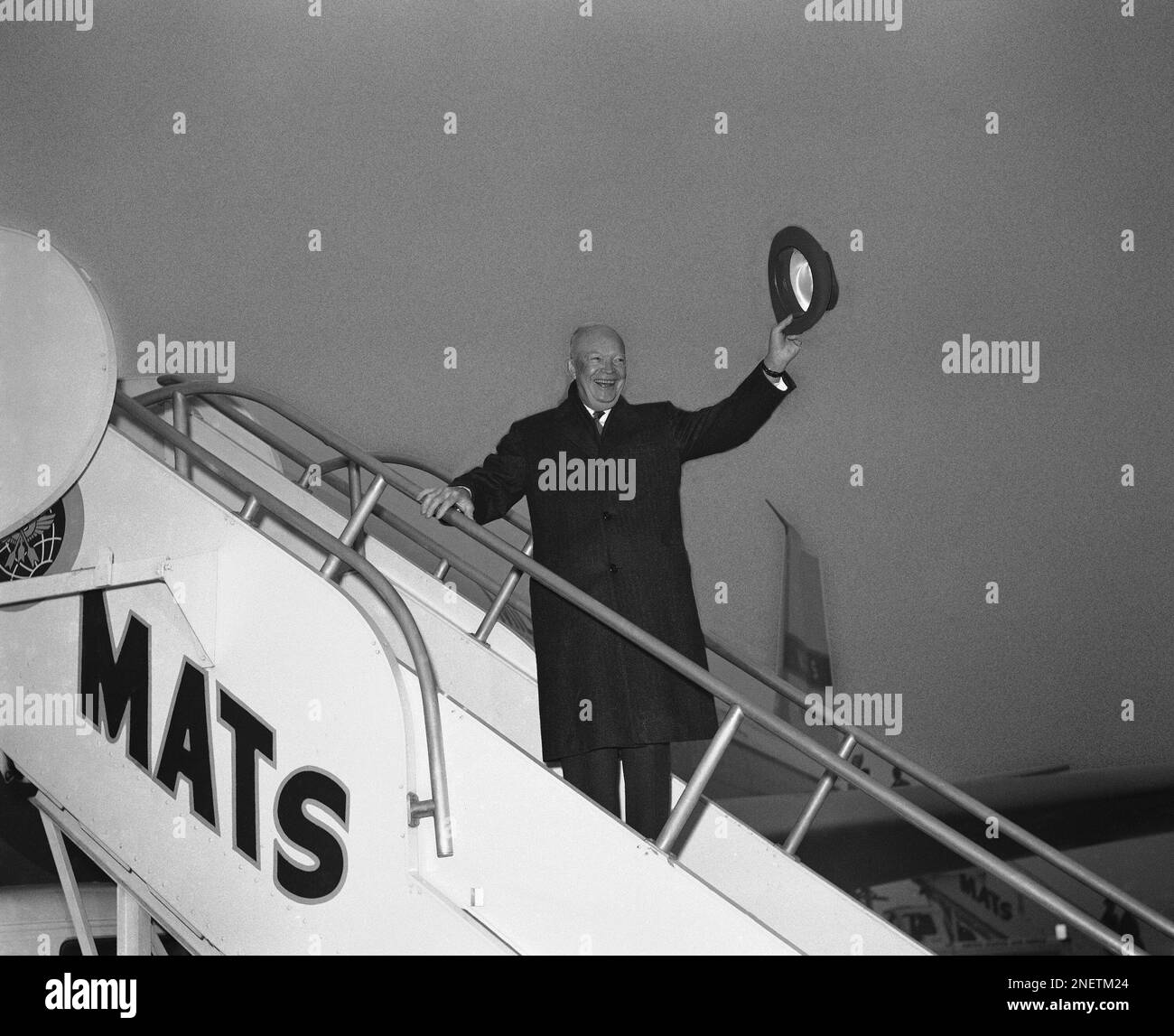 President Dwight Eisenhower turns and waves his hat as he boards his ...