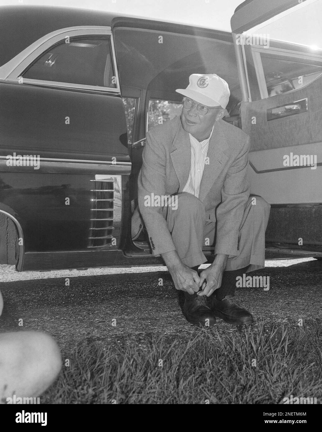 President Dwight D. Eisenhower sits on the floor of his limousine to ...