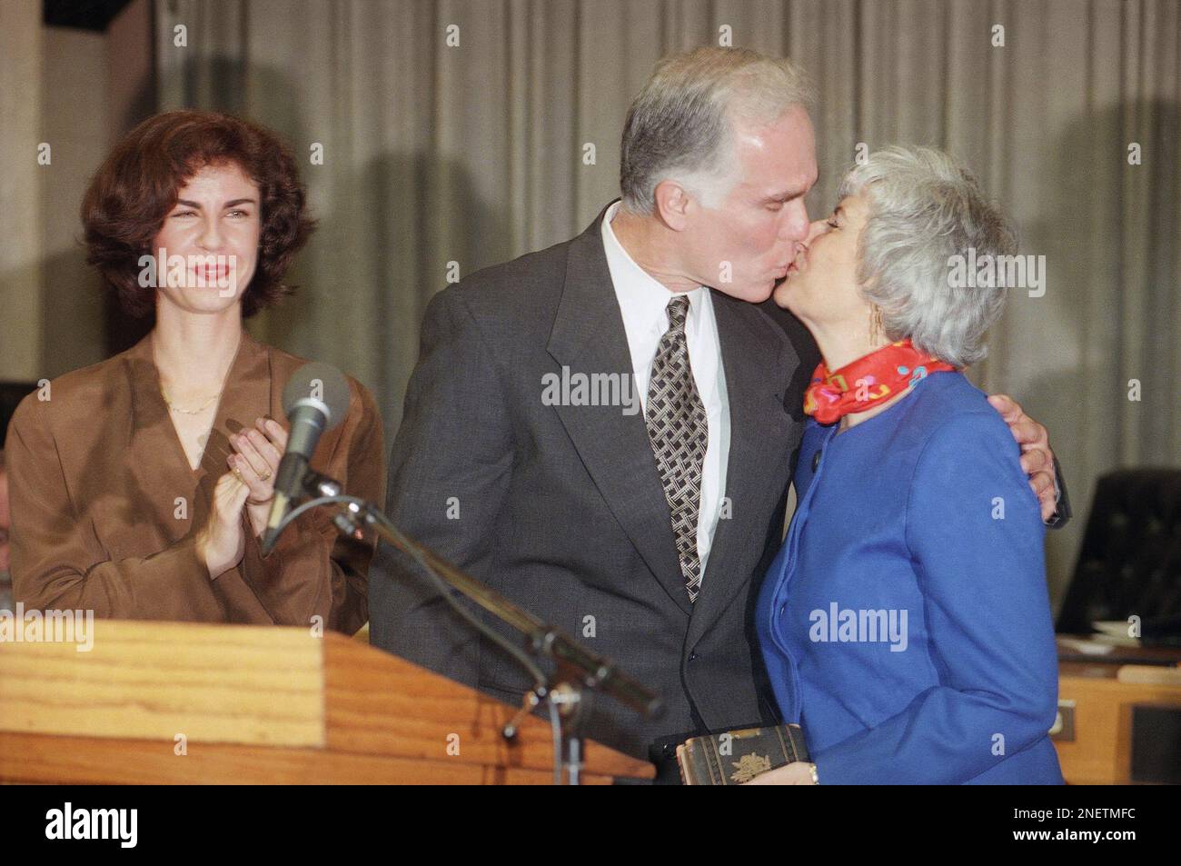 District Attorney Gil Garcetti, center, gives a kiss to his wife Suki ...