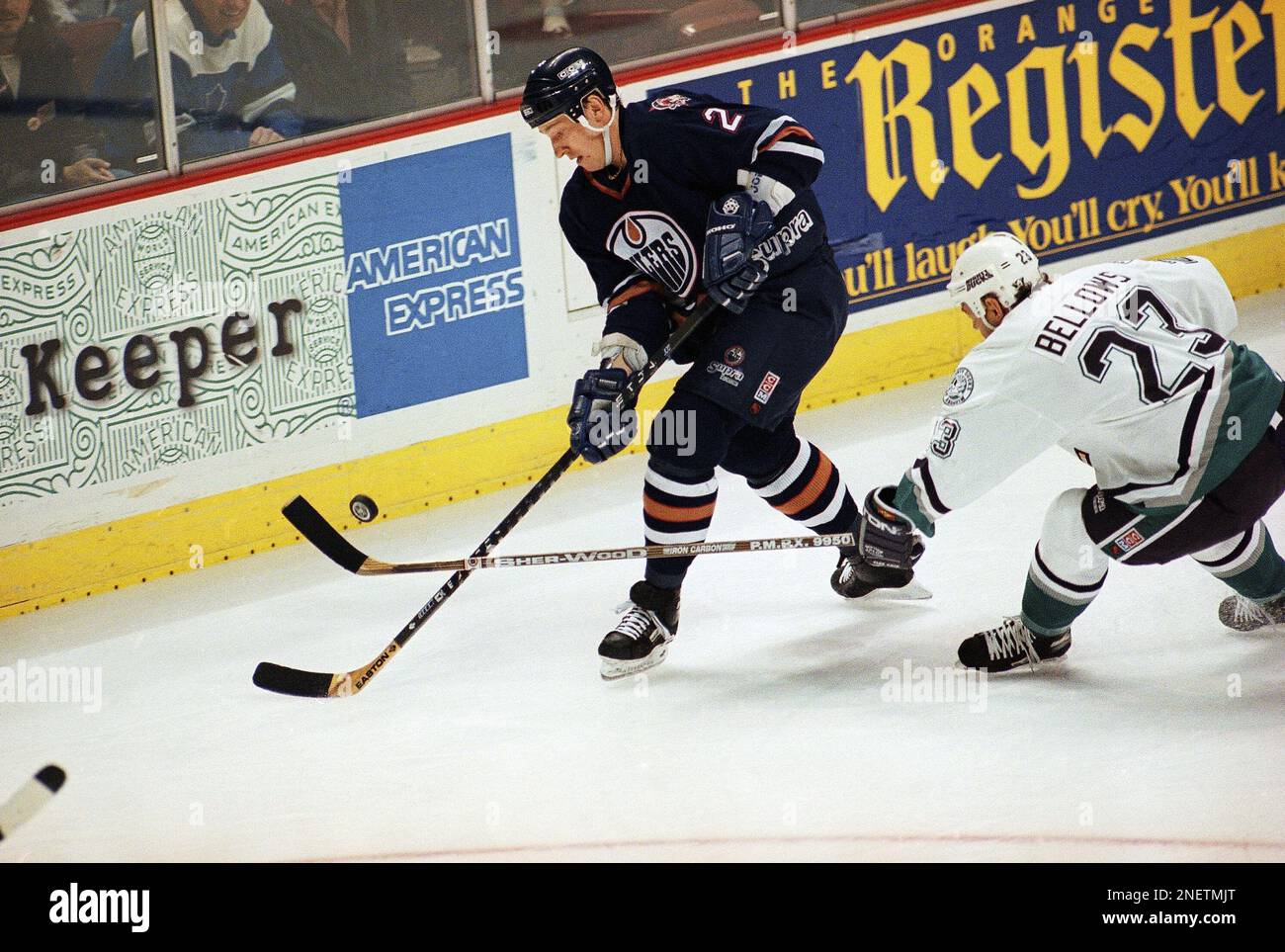 Edmonton Oilers’ Boris Mironov and Mighty Ducks’ Brian Bellows chase ...
