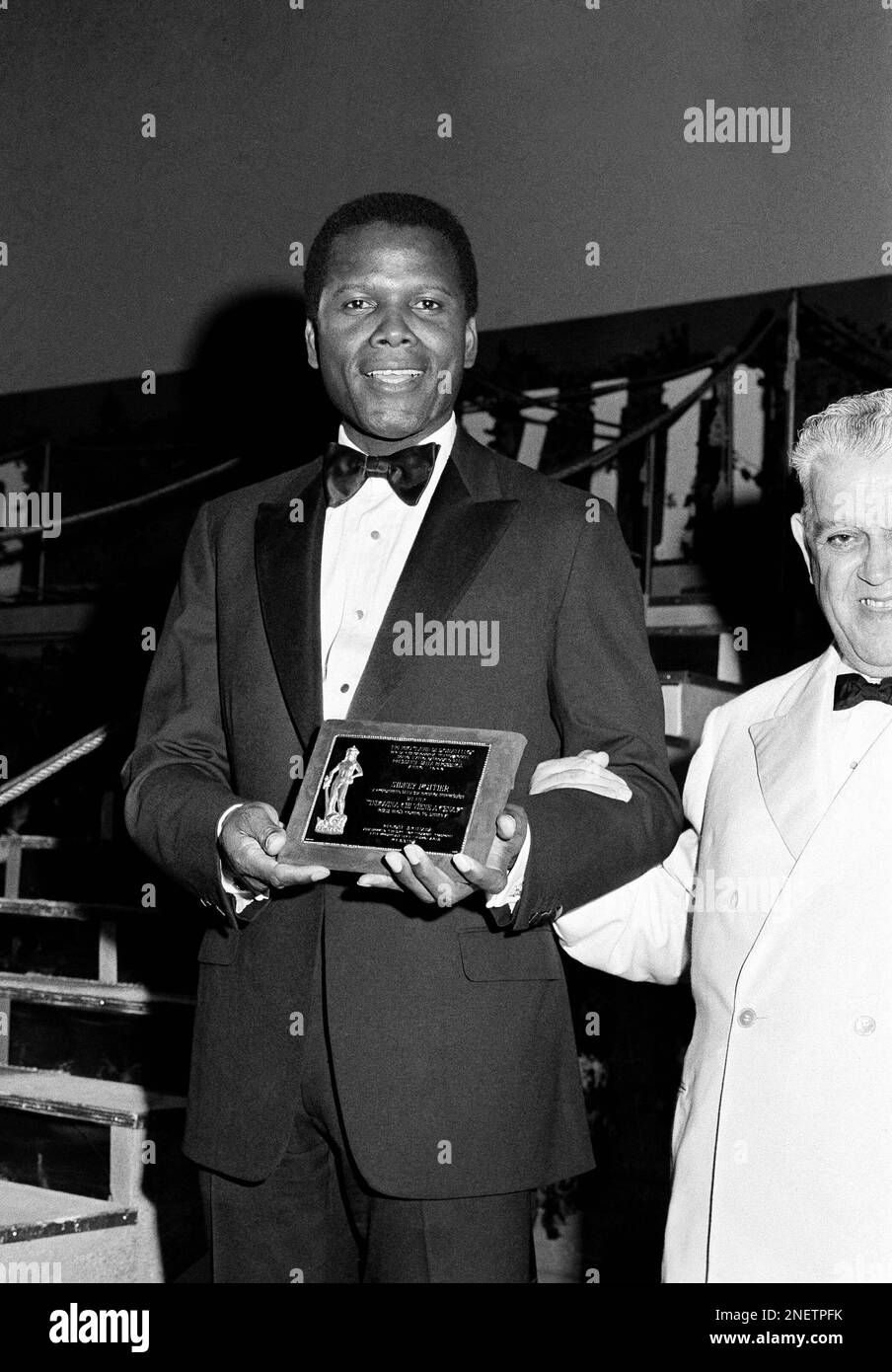 American actor Sidney Poitier holding a special citation he received at ...