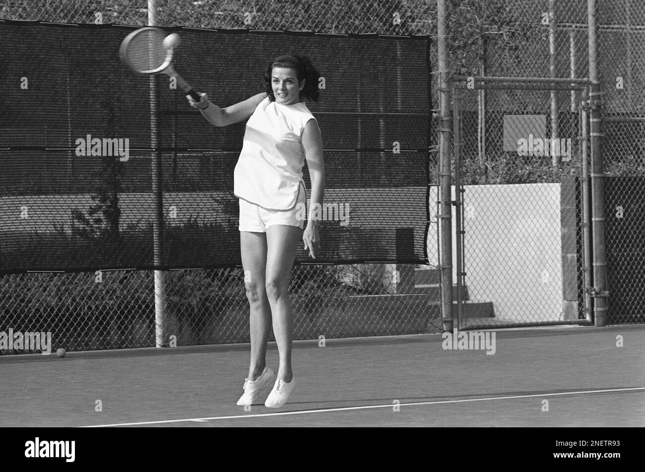 Actress Jane Russell takes tennis lessons from Gussie Moran at the Lake ...