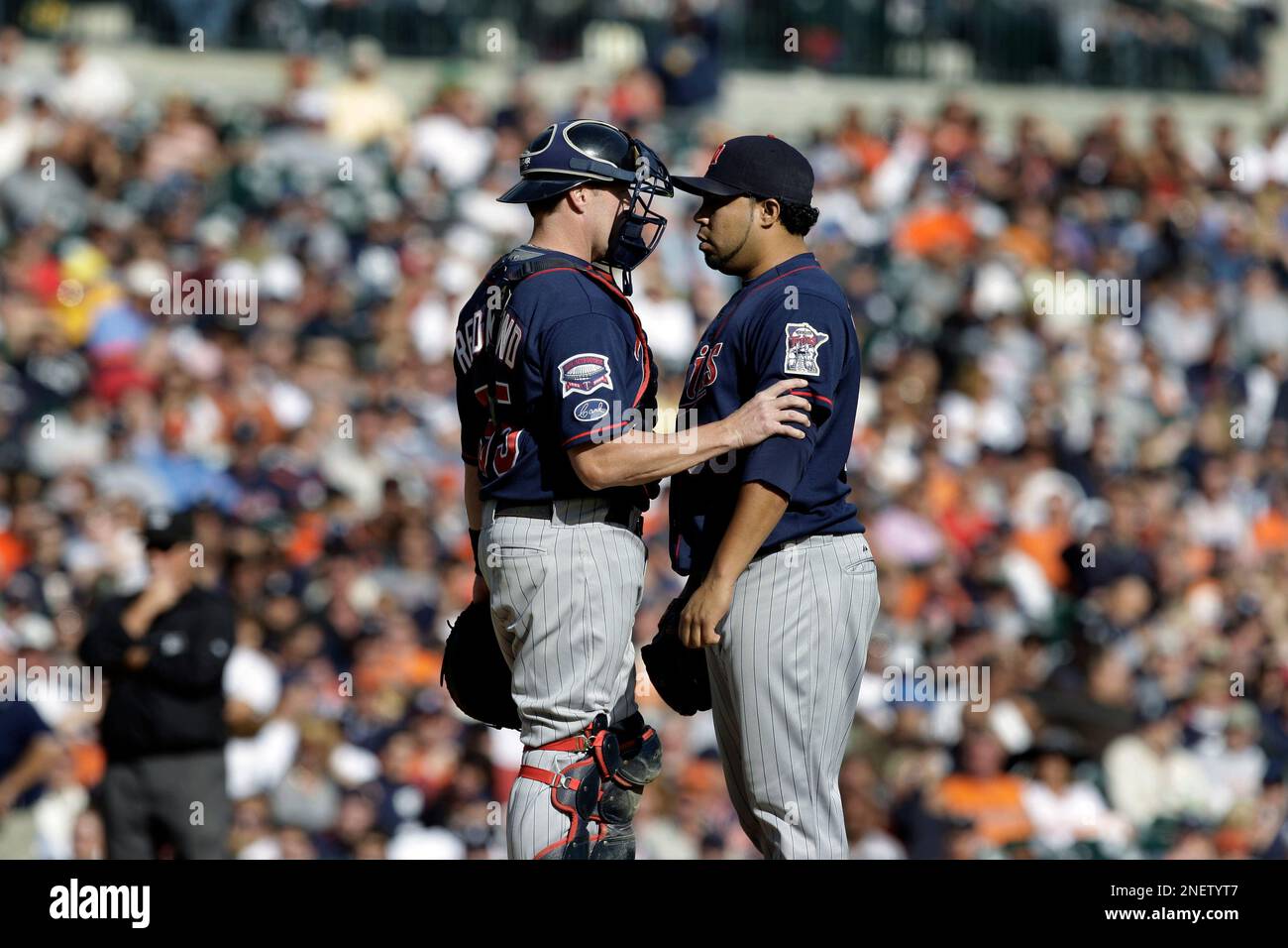 Minnesota Twins catcher Mike Redmond, left, talk with pitcher Jose ...