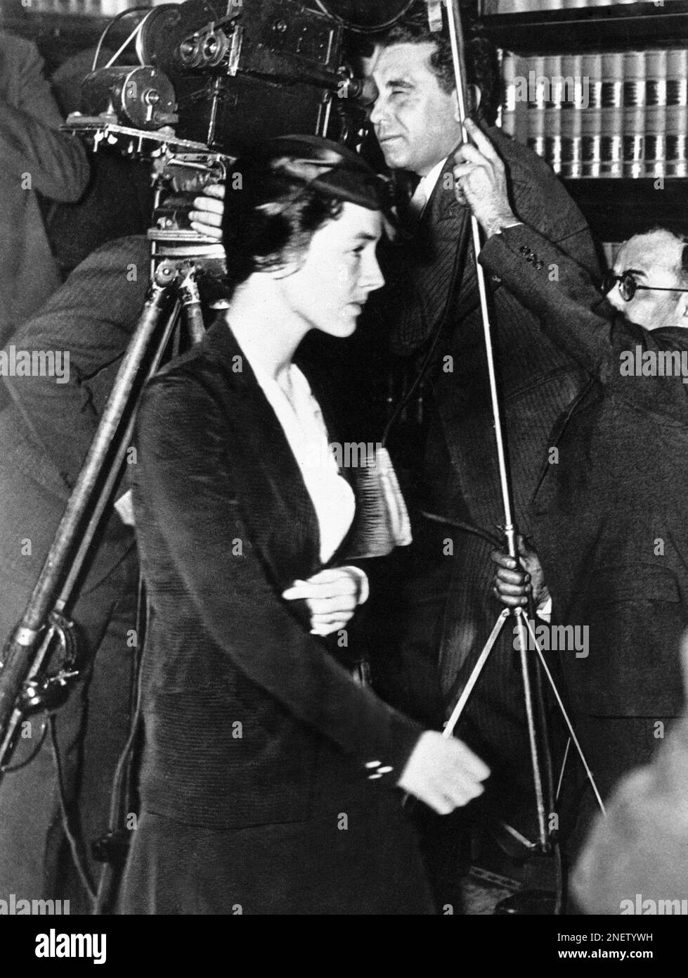 Mrs. Charles A. Lindbergh is shown above passing the battery of camera ...