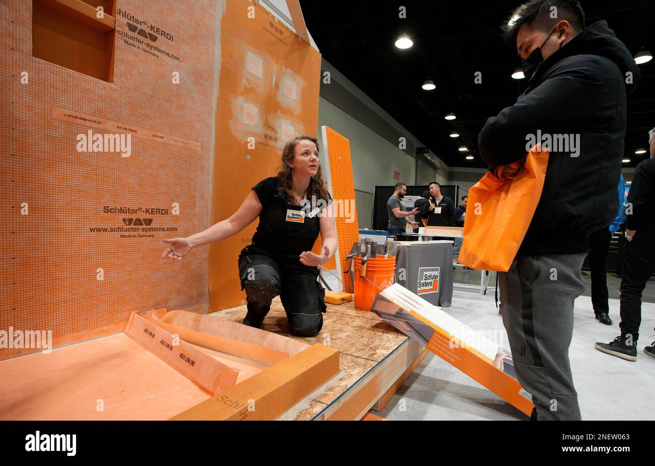 Vancouver, Canada. 16th Feb, 2023. A visitor (R) looks at a wall panel construction ...