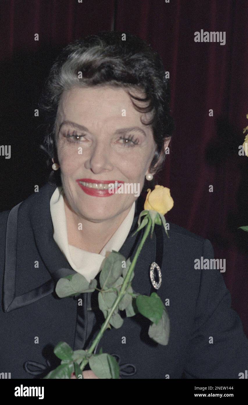Actress Jane Russell holds a single yellow rose, Dec. 6, 1983. (AP ...