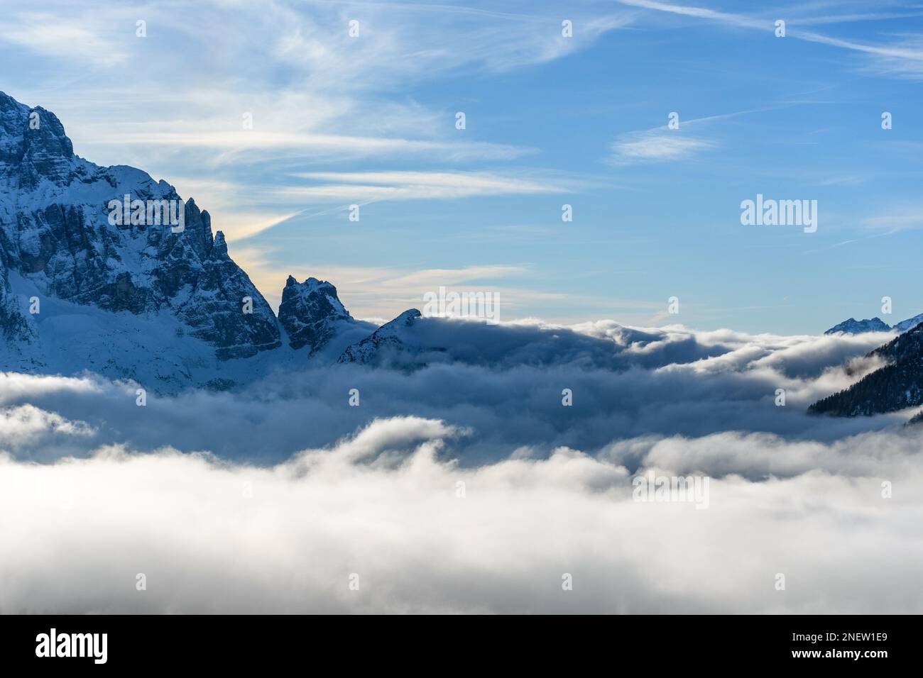 A gorgeous landscape with the snowy peaks of tall mountains emerging ...