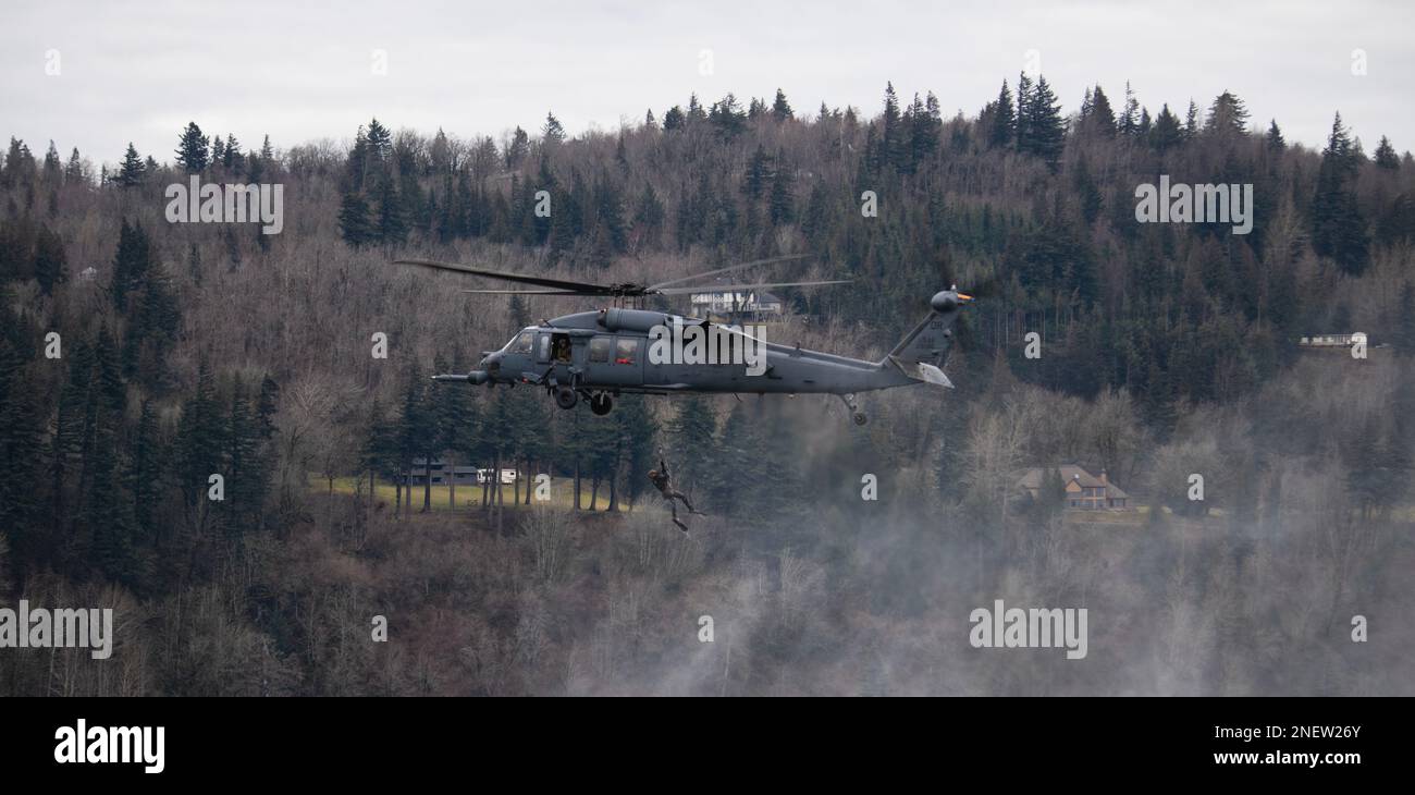 A 305th Rescue Squadron HH HH-60G Pave Hawk helicopter hovers over the ...