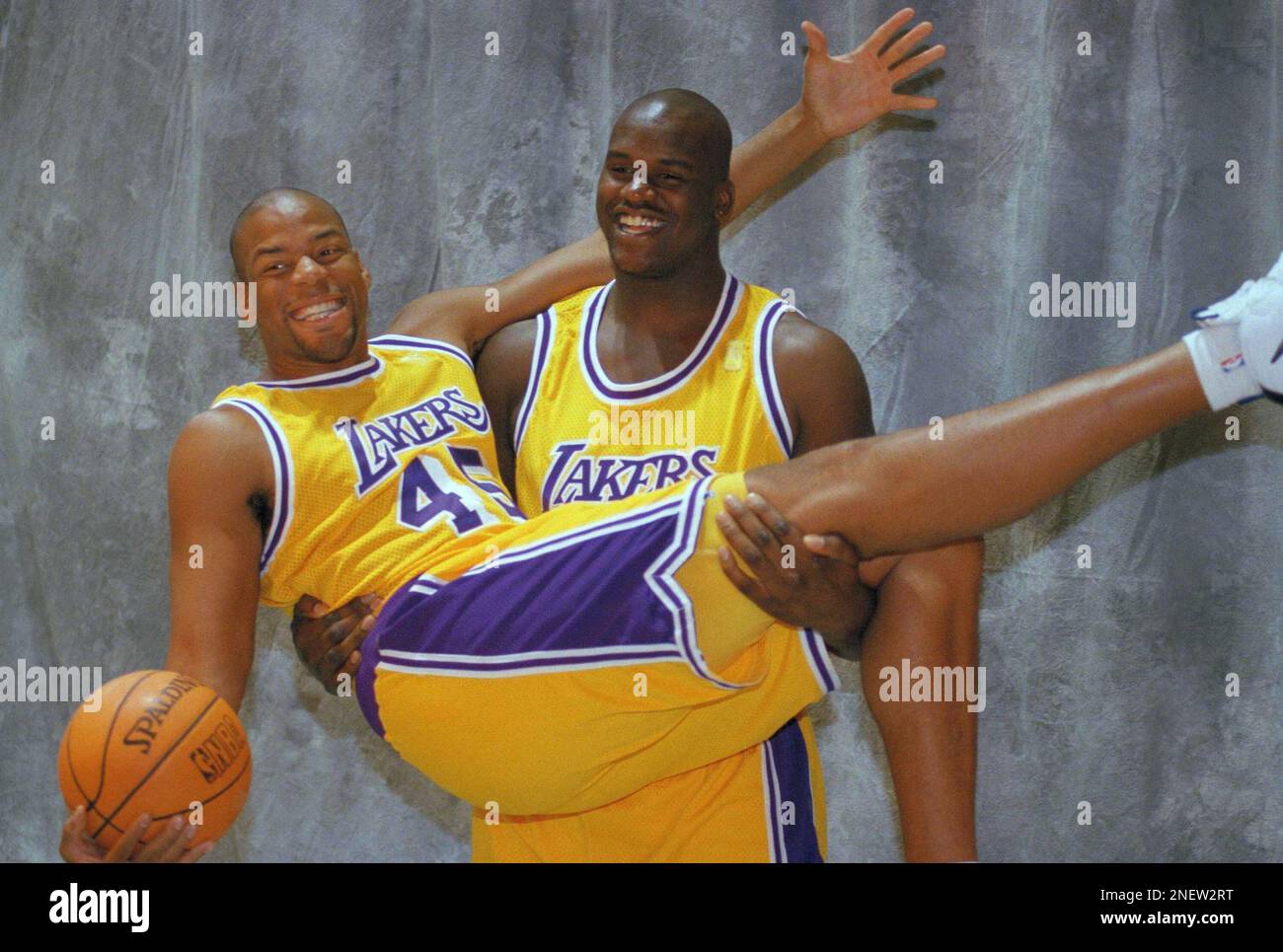 Los Angeles Lakers’ Shaquille O’Neal holds up fellow center Sean Rooks ...