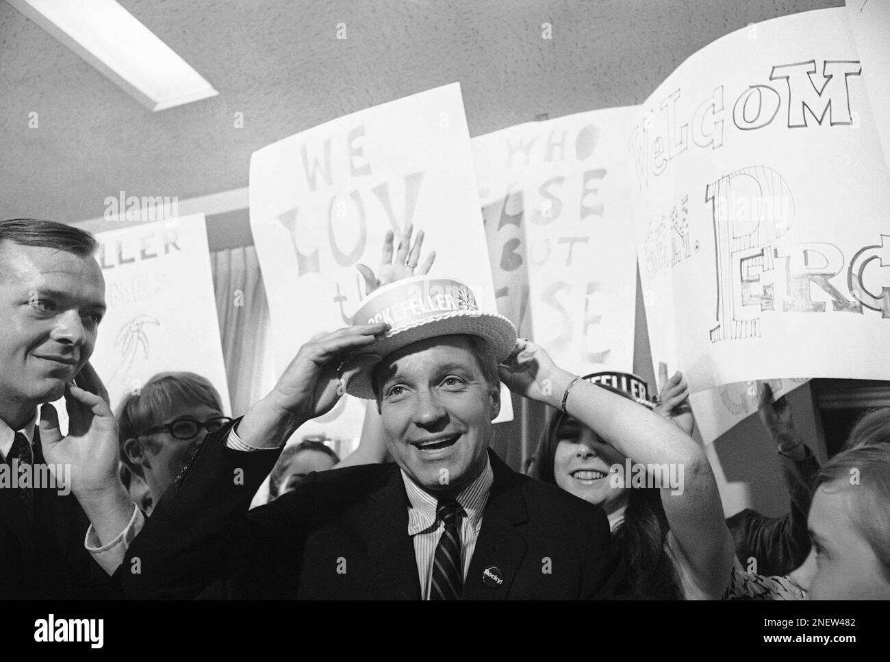Illinois Senator Charles Percy takes a look at a Rockefeller hat given ...